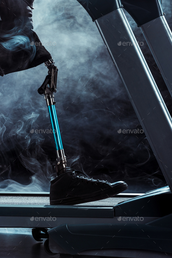 selective focus of paralympic sportsman with leg prosthesis training on ...