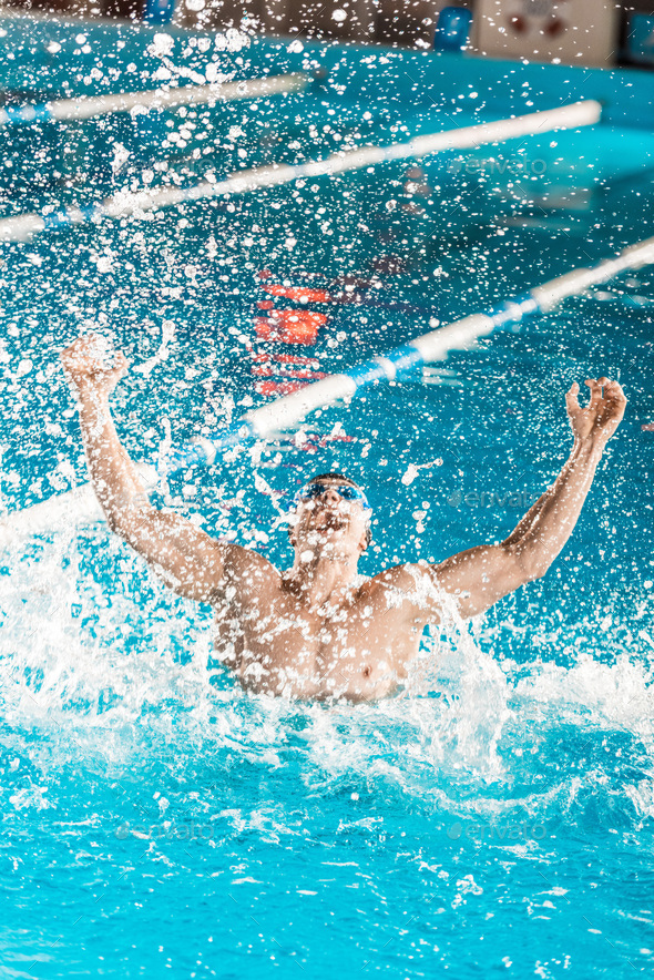 handsome winning muscular swimmer in competition swimming pool Stock ...