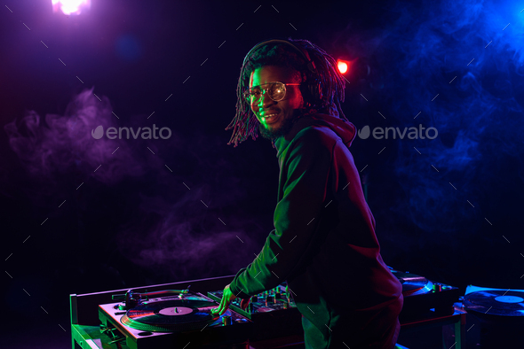 professional african american club DJ with sound mixer in nightclub ...