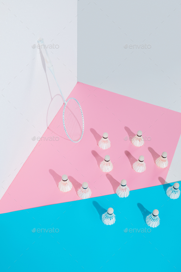 badminton racket and shuttlecocks on blue and pink papers Stock Photo ...