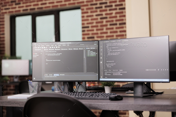 Pc desk with pc monitors running terminal window Stock Photo by DC_Studio