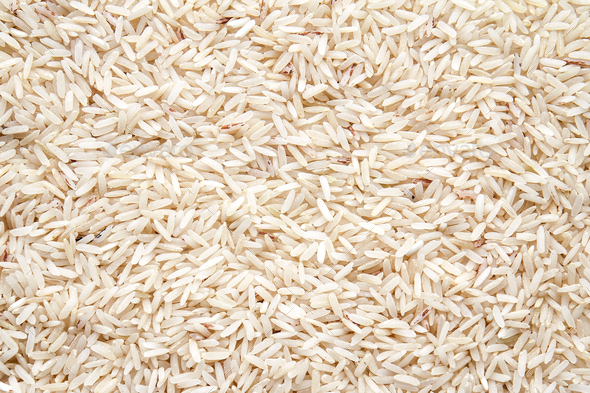 Organic raw rice texture can be use as background Stock Photo by tendo23