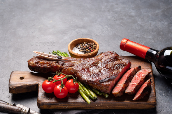 Medium rare grilled Tomahawk beef steak with asparagus Stock Photo by ...