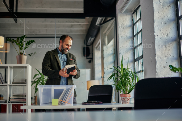 Taking stuff out of box for setting up office table Stock Photo by ...