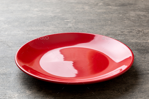Perspective view of empty red plate on cement background. Empty space ...