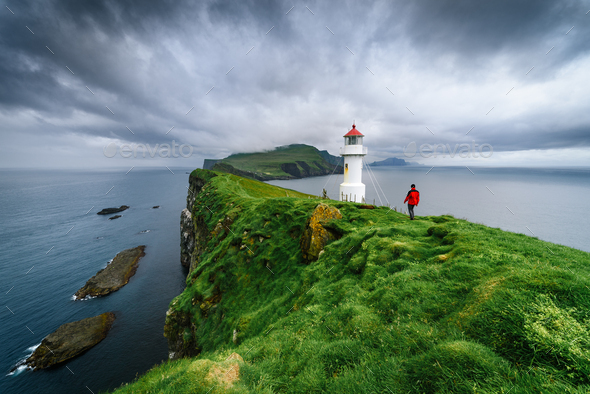 Hiking in Mykines near Holmur Lighthouse, Faroe Islands Stock Photo by ...