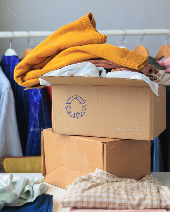 recycling, old clothes in cardboard box. textiles, paper at home and ...