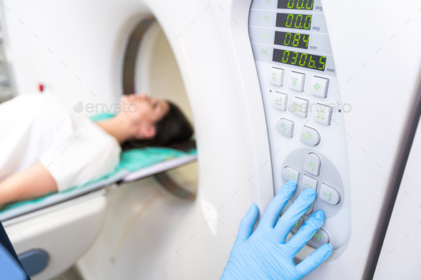 beautiful woman lying on ct scanner bed during tomography test in ...