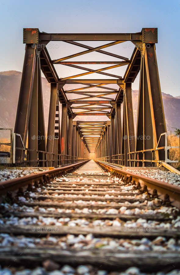 Old metal rail road bridge. With symmetrical metal structure and track ...