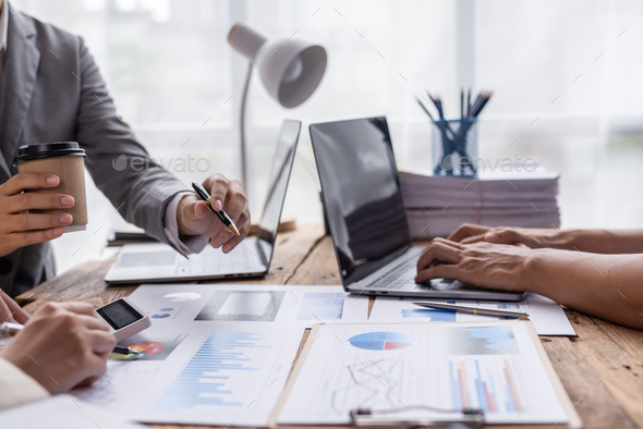 Business People Meeting using chart graph calculator, laptop computer ...