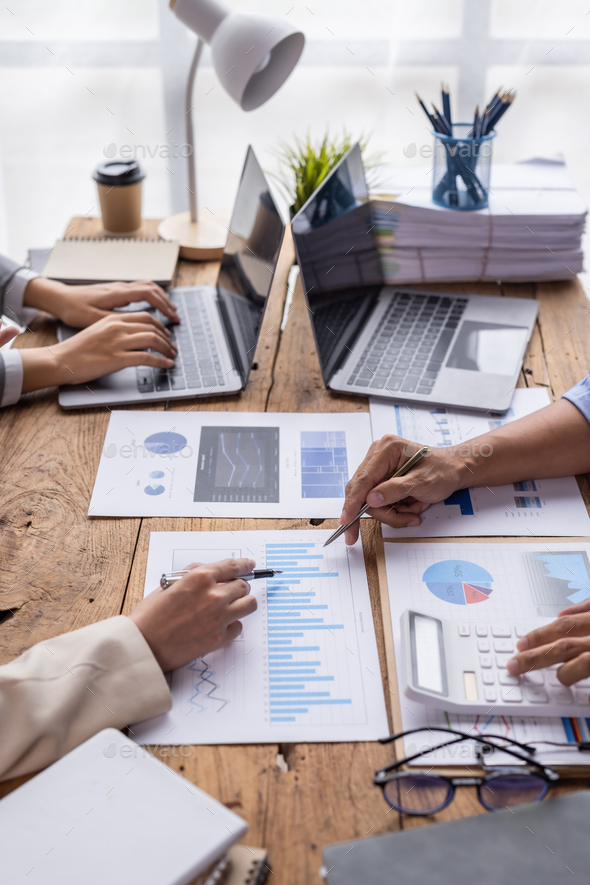 Business People Meeting using chart graph calculator, laptop computer ...