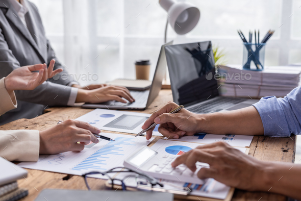 Business People Meeting using chart graph calculator, laptop computer ...