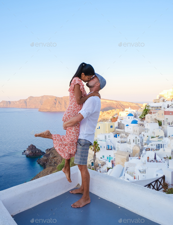 Couple hugging and kissing on a romantic vacation in Santorini Greece ...