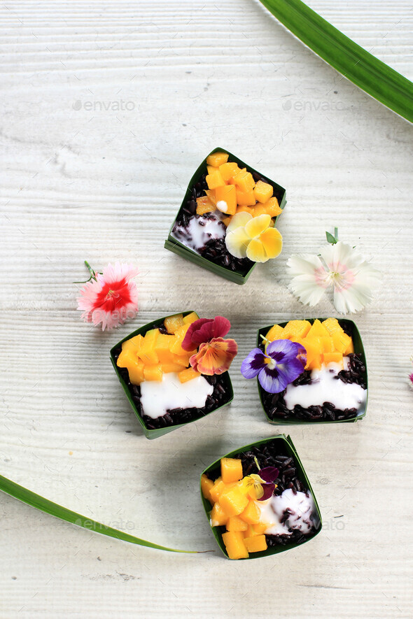 Homemade Coconut Black Sticky Rice with Mango in Pandan Leaves Cup ...