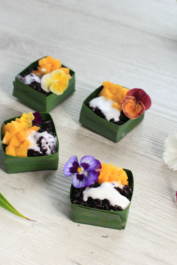 Homemade Coconut Black Sticky Rice with Mango in Pandan Leaves Cup ...