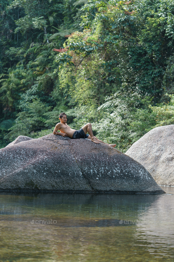 japanese man sunbathing on a stone in a river in Australia Stock Photo ...