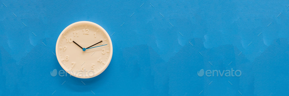 White big analogue plain wall clock on trendy pastel blue background ...