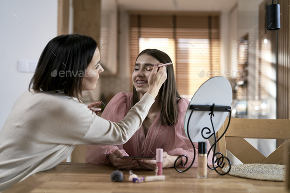 Teenage girl getting ready for prom with mom at home Stock Photo by ...