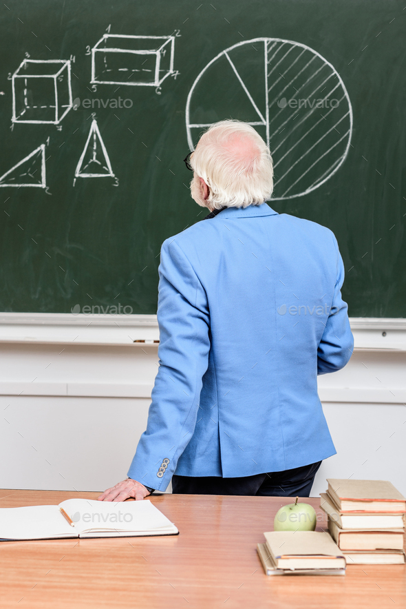 rear view of grey hair professor looking at blackboard Stock Photo by ...