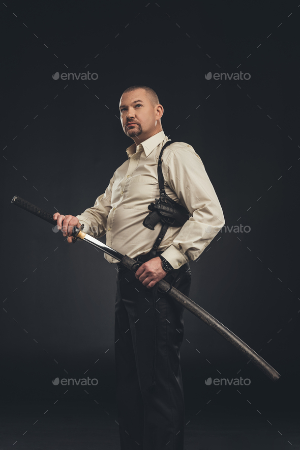 mature yakuza member taking out his katana sword Stock Photo by ...