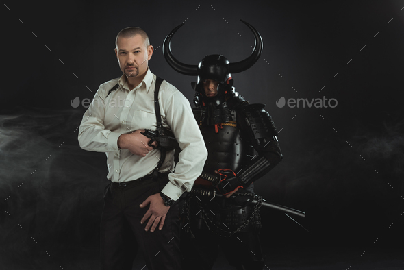 man with gun and armored samurai behind him on black Stock Photo by ...