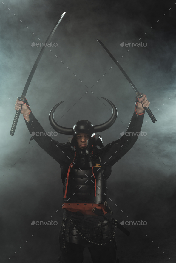 samurai in armor with dual katana swords on dark background with smoke ...