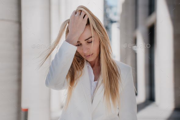 Frustrated blonde caucasian woman walking eyes looks down with upset ...
