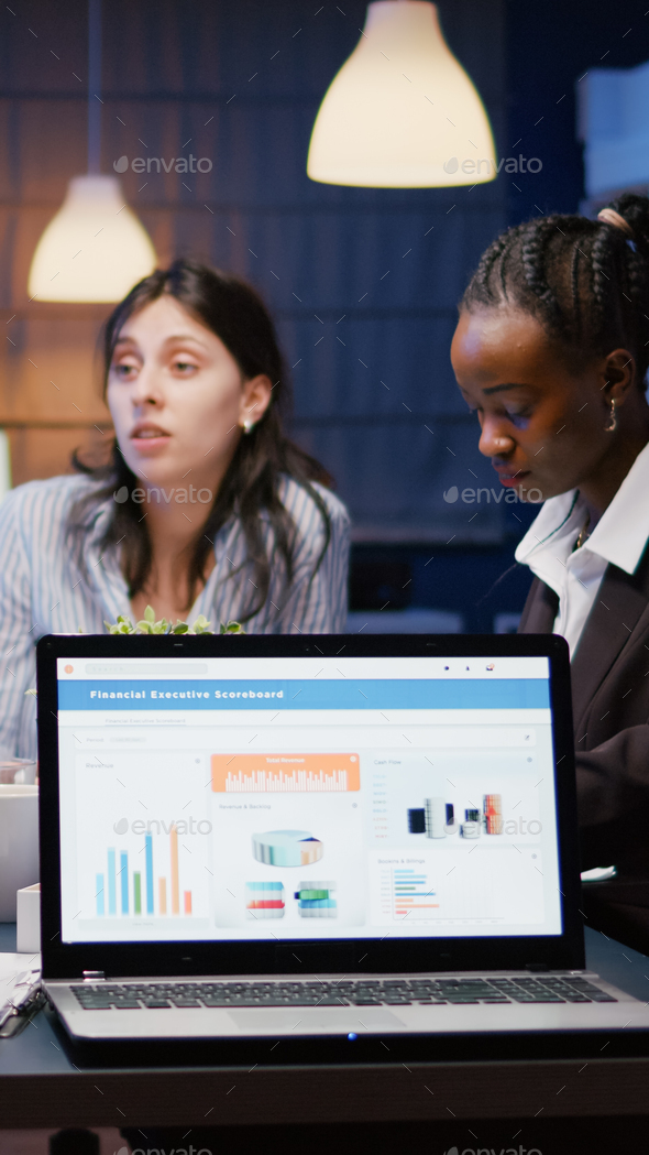 Laptop computer with financial graphs presentation on monitor standing ...