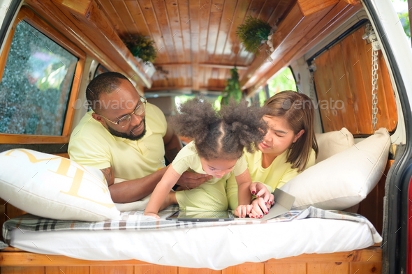 The back of a white classic van, little kids play and learn about the ...