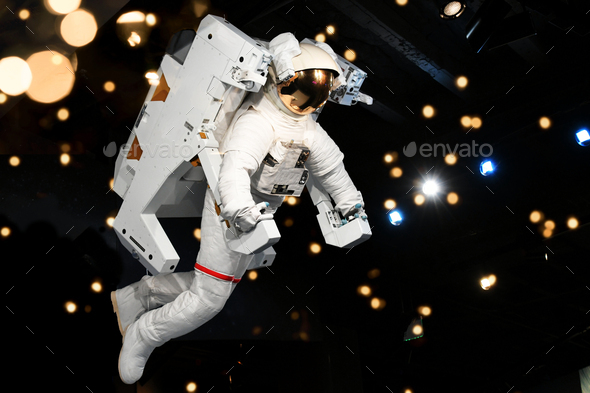 Display of generic astronaut in flight suit going on spacewalk in ...