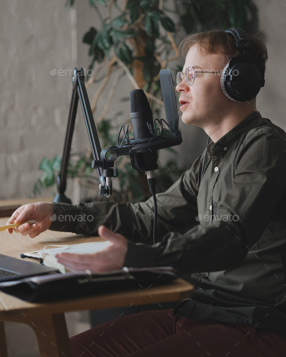 man in studio is recording podcast, audio content of interview on radio ...