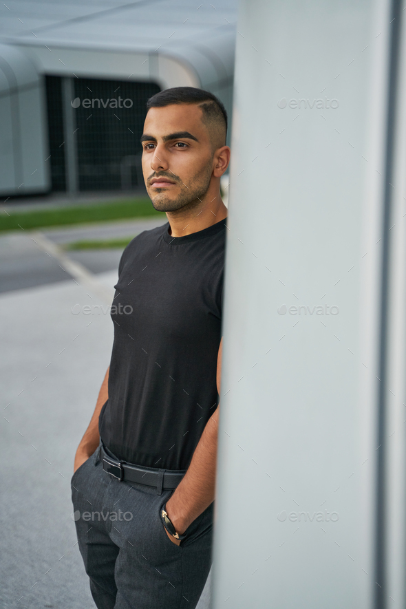 Serious Iranian male fashion posing while standing outdoors Stock Photo ...