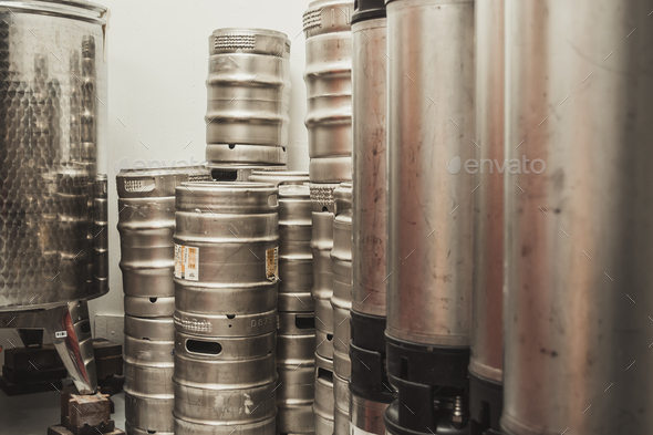 Inside of fermentation chamber in craft brewery, tanks and kegs with ...