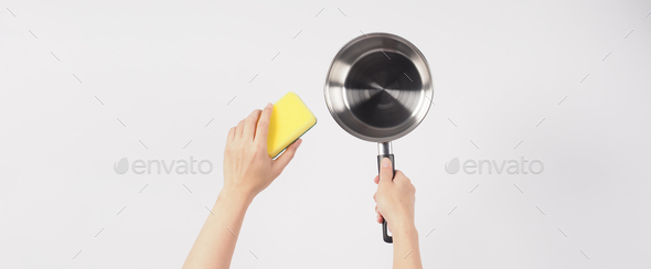 Pot cleaning Man hand on white background cleaning the non stick pot ...