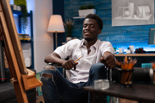 Portrait of young illustrator with disability smiling at camera Stock ...