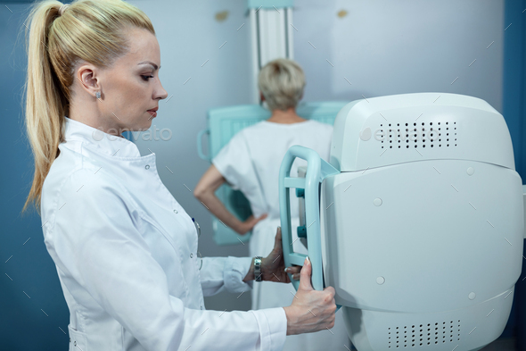 Nurse monitoring X-ray procedure of a patient in the hospital. Stock ...