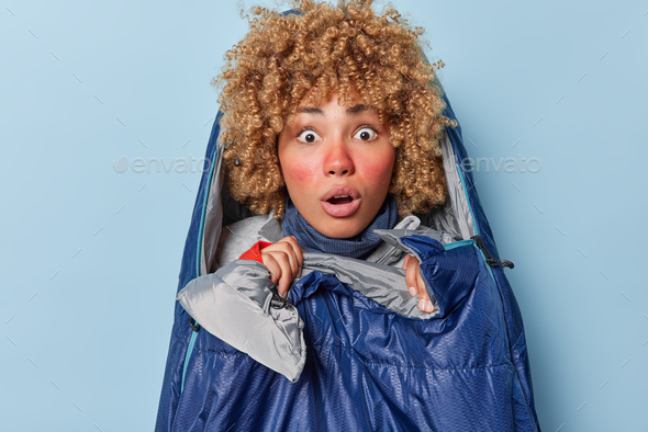 Shocked female hiker stares with omg expression cannot believe own eyes ...