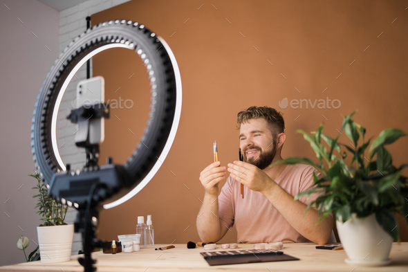 Man vlogging about make up and beauty products. Male shooting a makeup ...