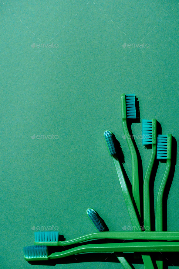 top view of green toothbrushes, on green with copy space Stock Photo by ...