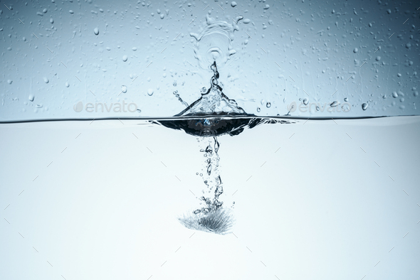 ice cube splashing in water with drops, isolated on white Stock Photo ...