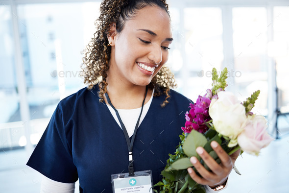 Achievement, celebration and a doctor with flowers at a hospital for a ...