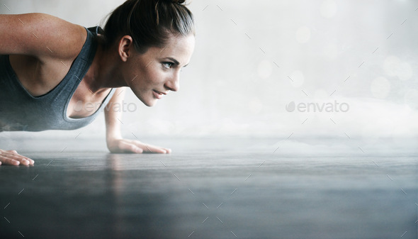 Fitness, power and woman doing a pushup at the gym for strength ...