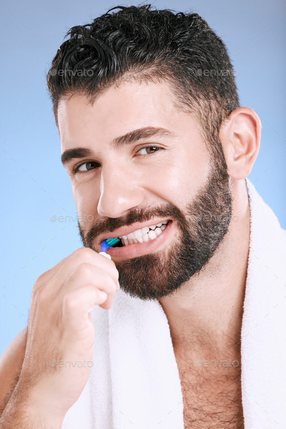 Brushing teeth, man and studio portrait of toothbrush for dental wellness, healthy lifestyle or ...