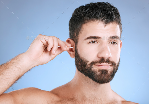 Ear, cleaning and man with cotton bud in studio for hygiene, grooming ...