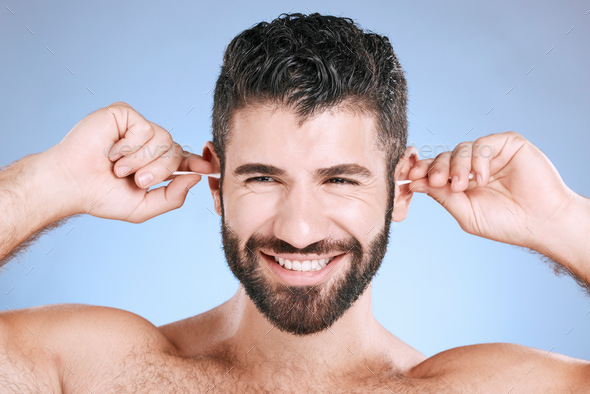 Cleaning, ear and man with cotton bud in studio for hygiene, grooming ...