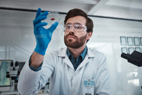 Science, blood and sample with a doctor man at work in a laboratory for ...