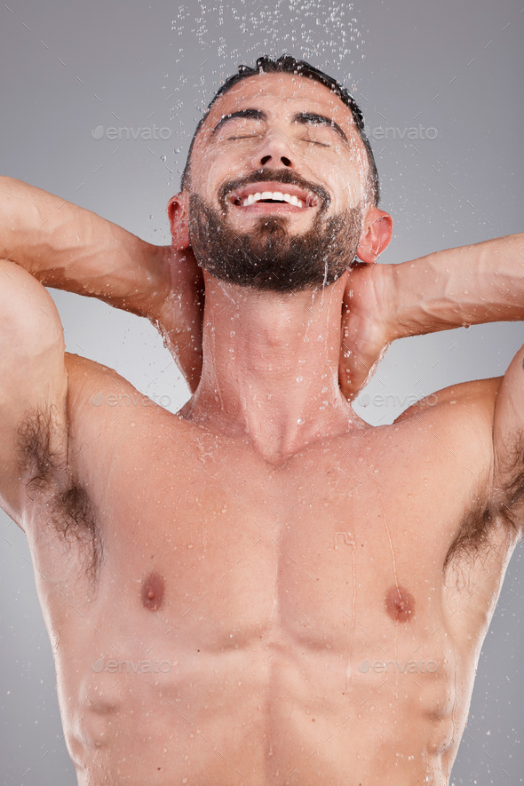 Shower, beauty and happy man isolated on studio background with water ...