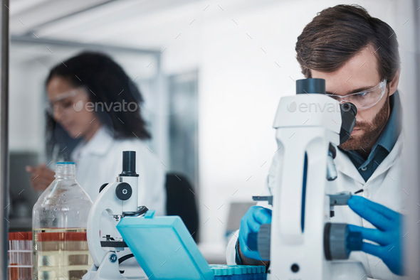 Man, doctor and forensic science with microscope for examination ...