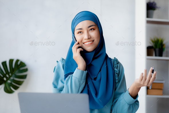 Asian women in hijab are talking on the phone, administration and ...