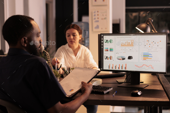 Corporate worker analyzing business report data on computer screen ...